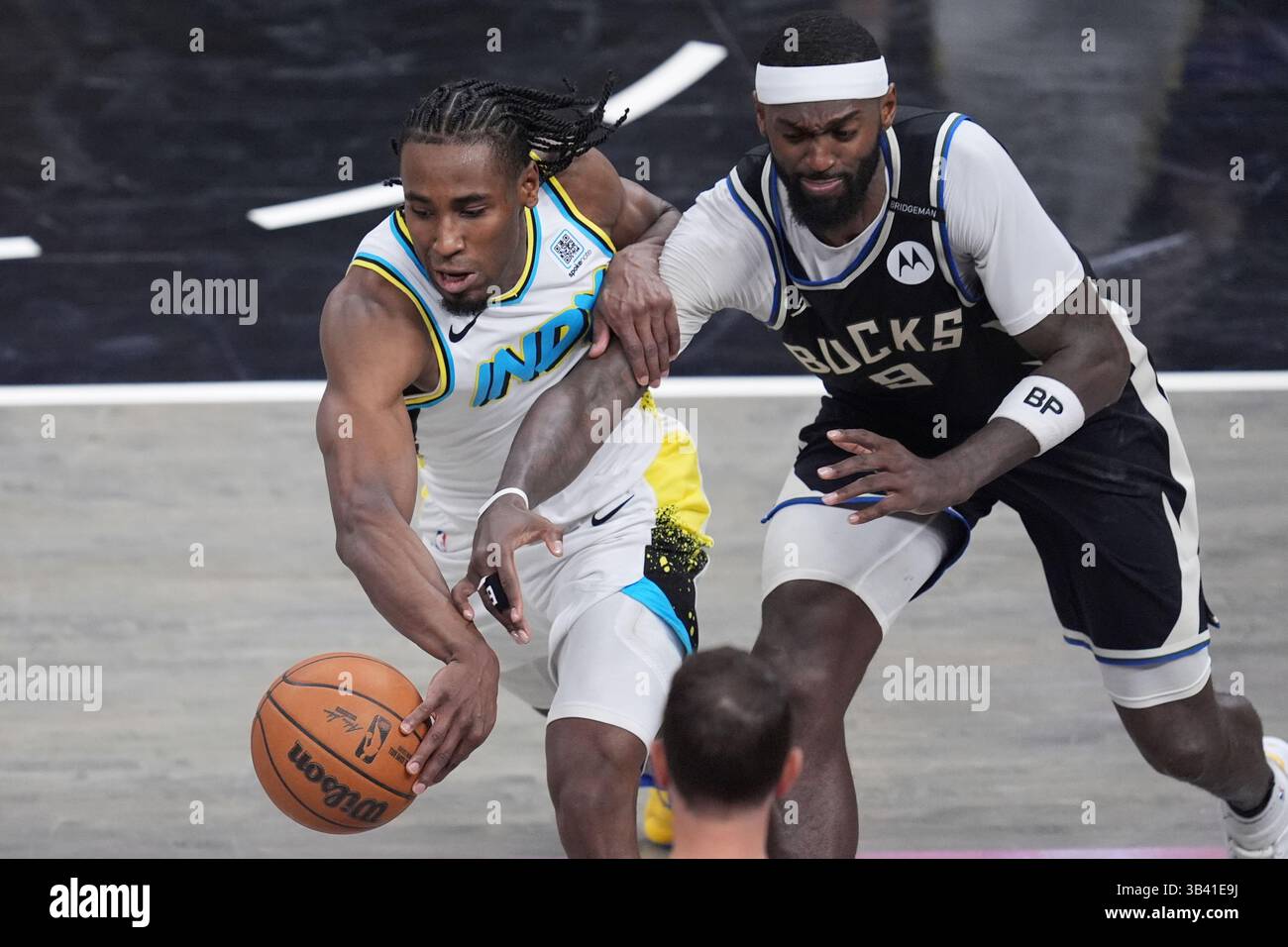 Indiana Pacers forward Aaron Nesmith, left, chases the ball past ...