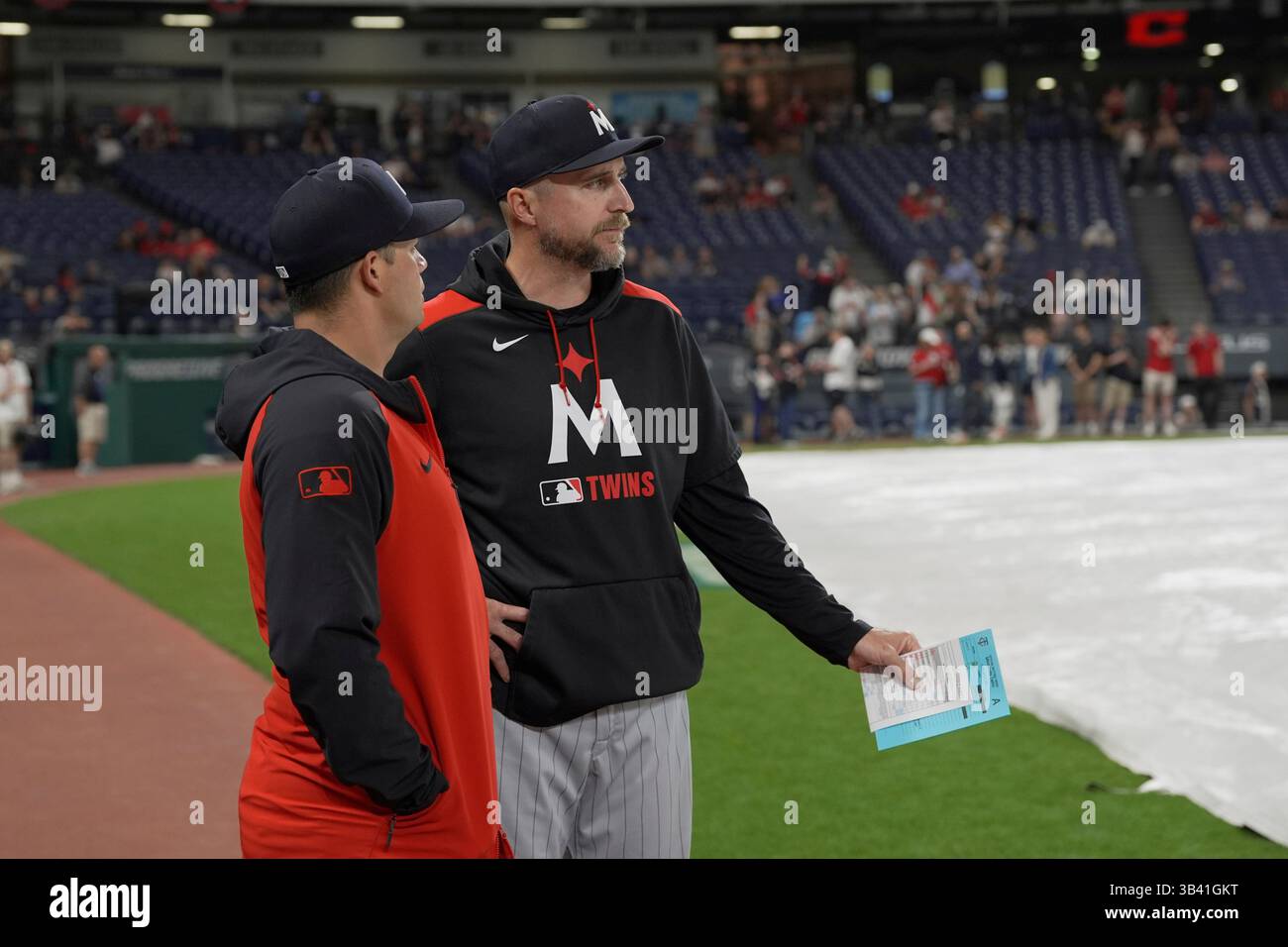 Minnesota Twins manager Rocco Baldelli (5), right, looks over the field ...