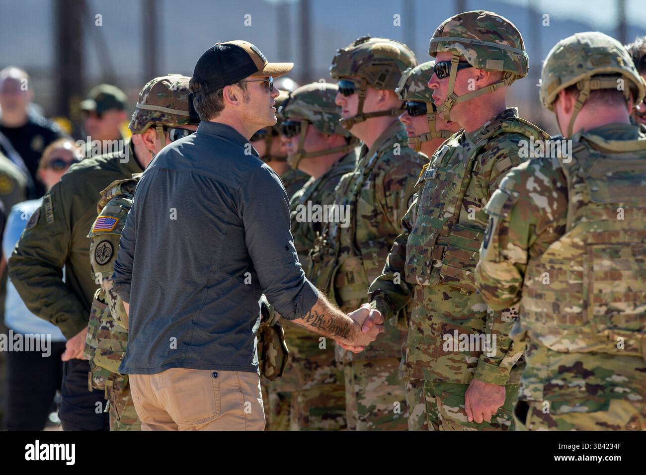 FILE - Defense Secretary Pete Hegseth, left, shakes hands with an Army ...