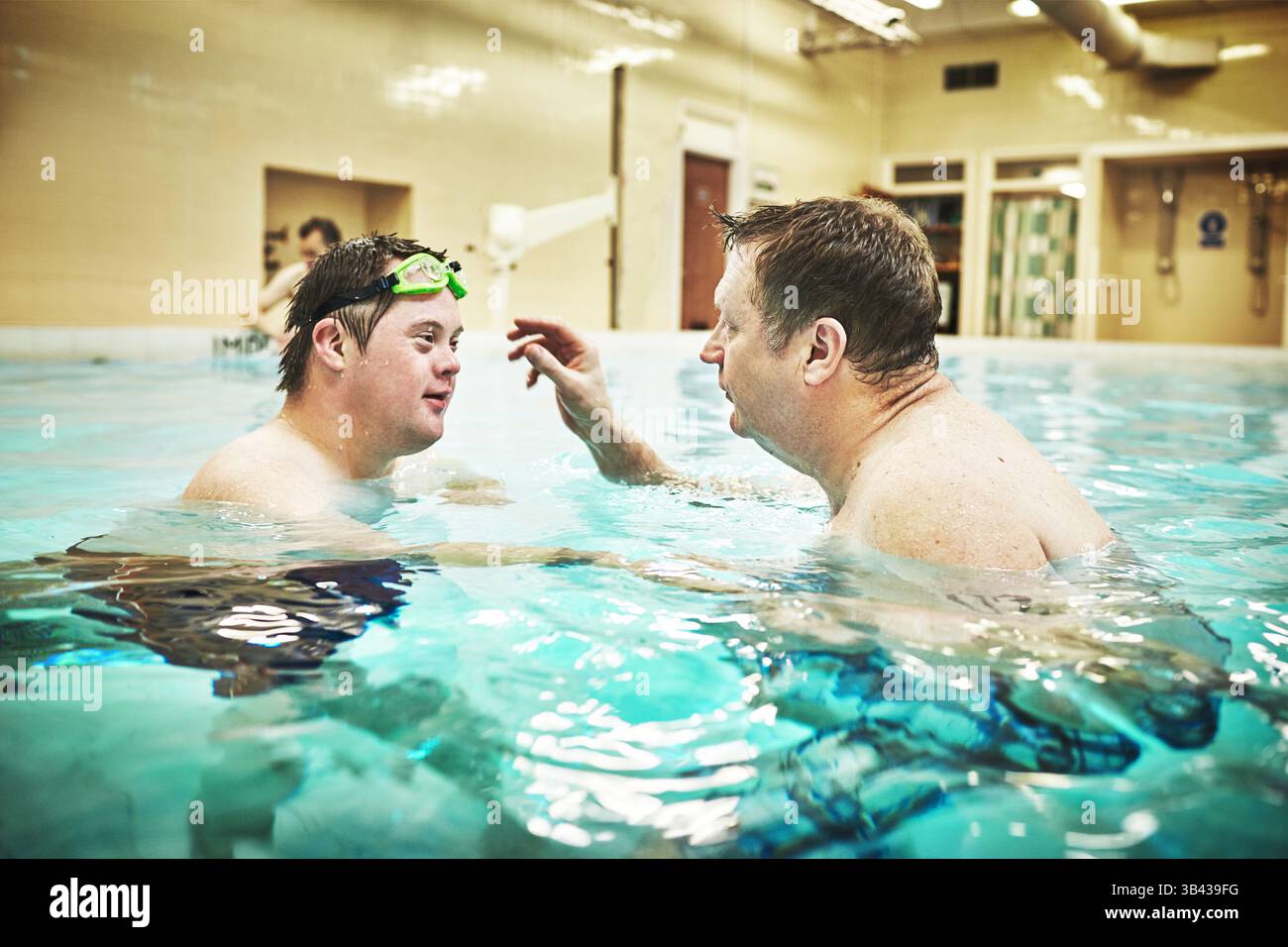 Pool, disability and down syndrome man in swimming class for exercise ...
