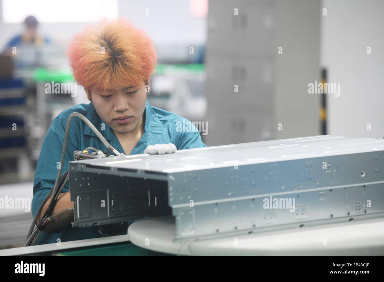 HANGZHOU, CHINA - APRIL 30, 2025 - A worker is manufacturing high ...