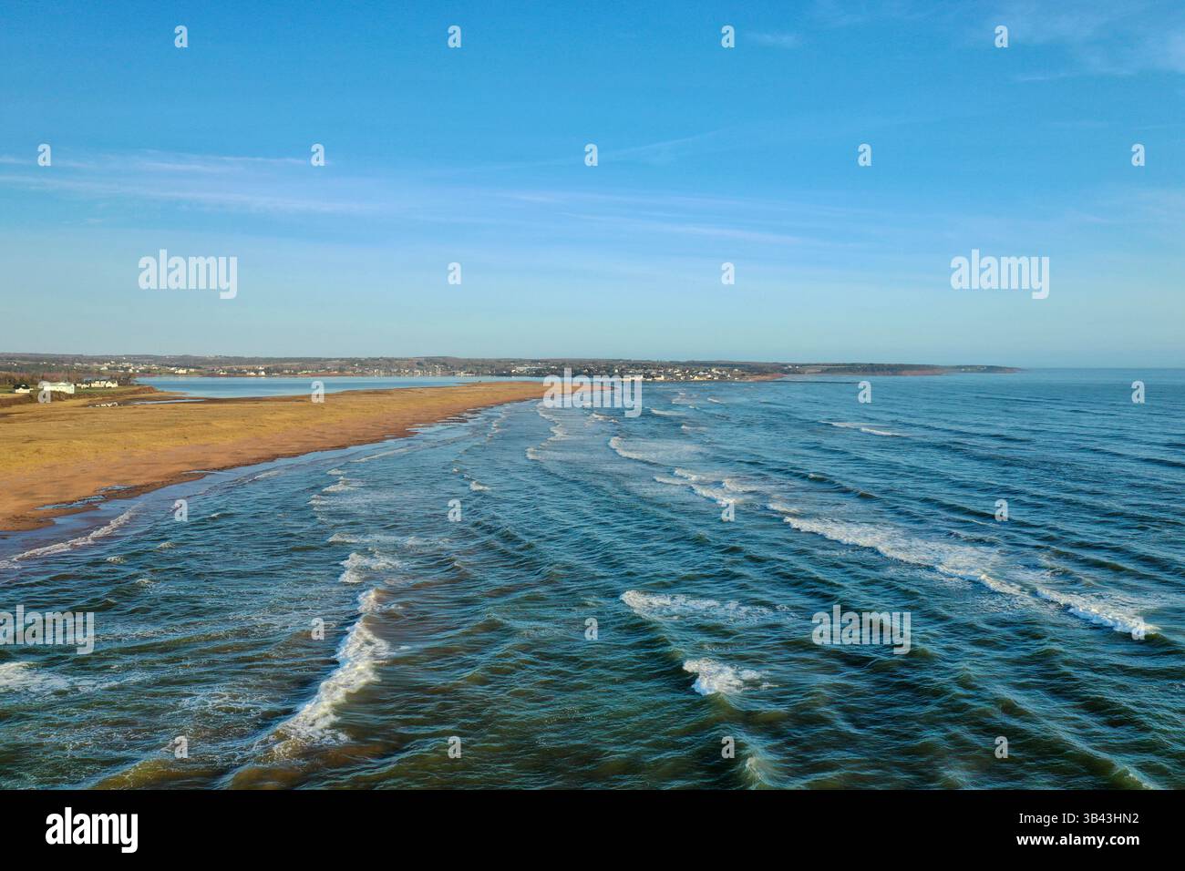 Aerial shot capturing the contrast between dark ocean waves and bright ...