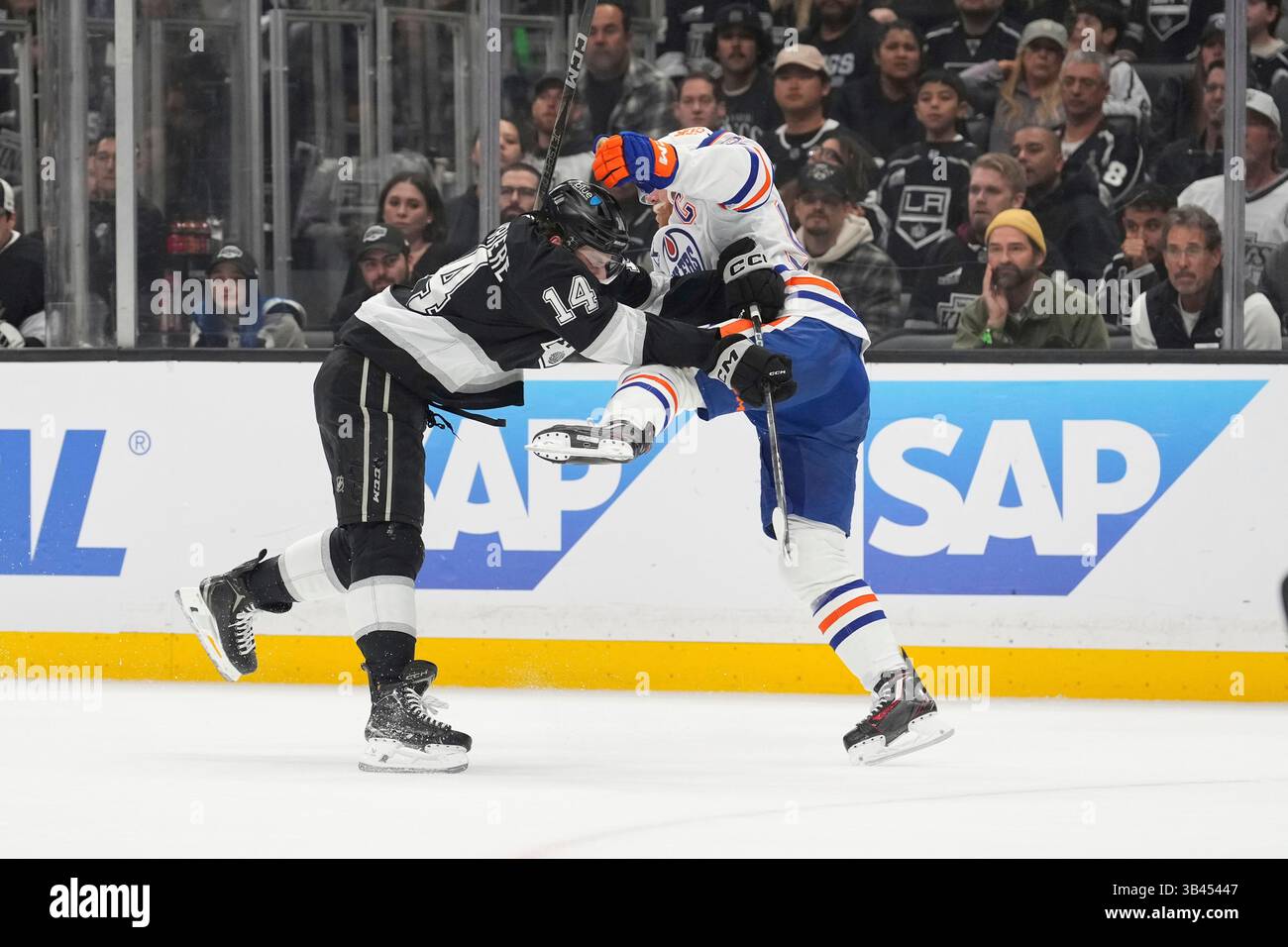 Los Angeles Kings right wing Alex Laferriere, left, puts a hit on ...