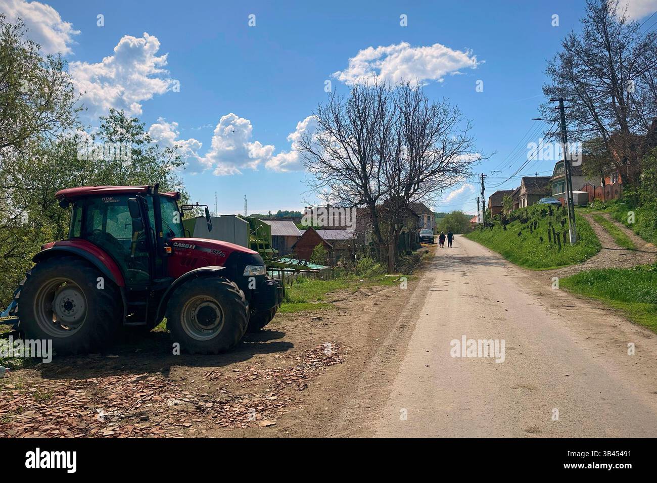 People walk on a road in the village of Saschiz, in Romania's central ...