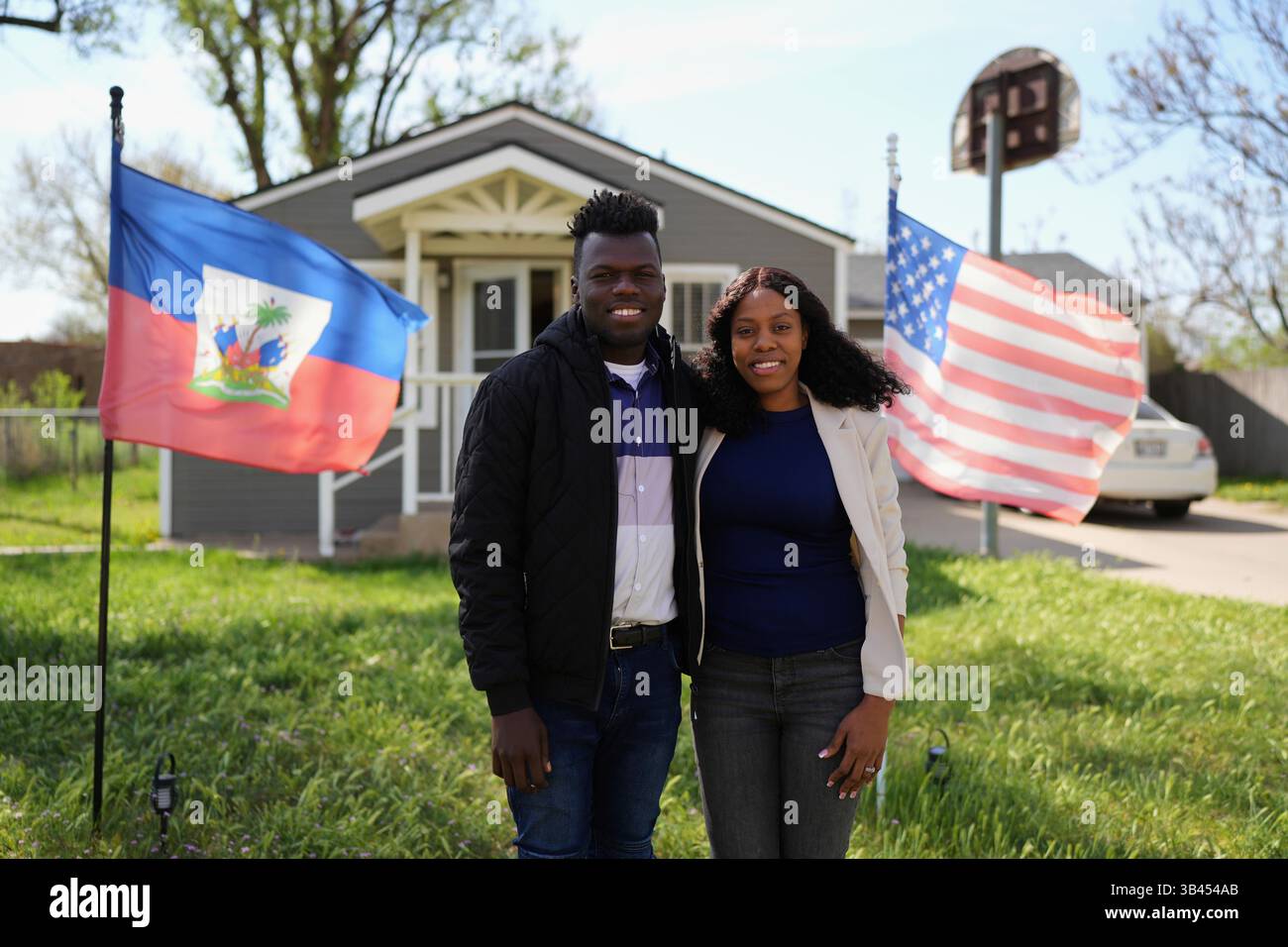 Haitian immigrants Kevenson Jean, a truck driver, and wife Sherlie Jean ...