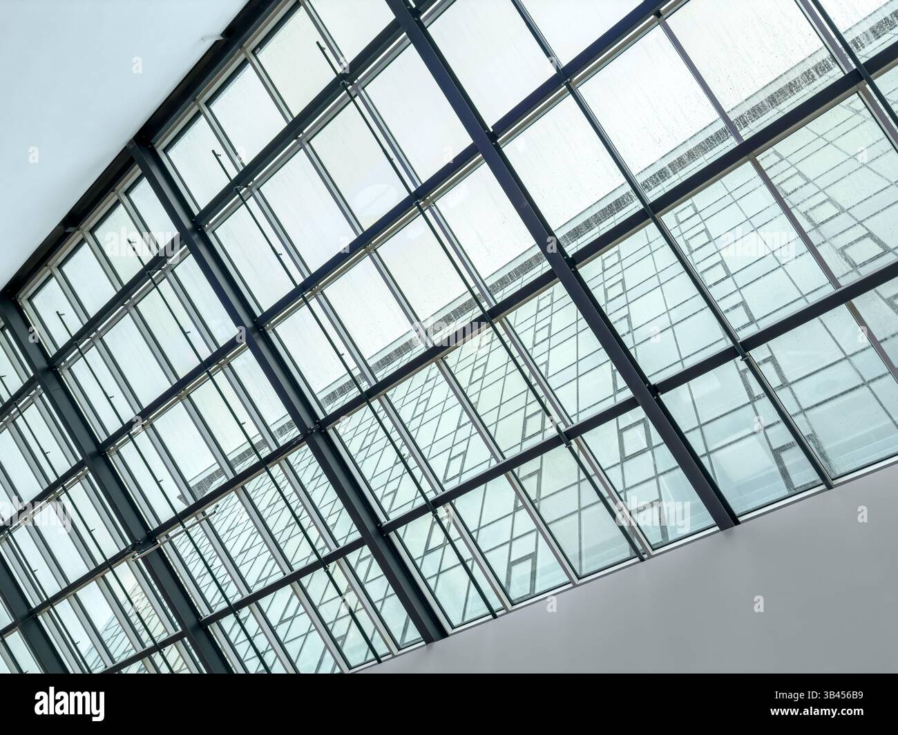 transparent glass roof of shopping mall with raindrops at rainy day ...
