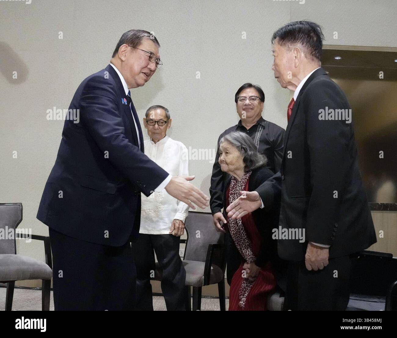 Japanese Prime Minister Shigeru Ishiba (L) meets with descendants of ...