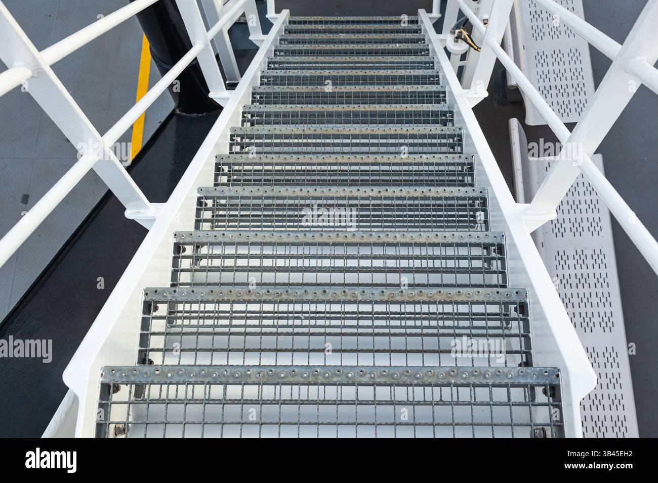Ship's steel ladder with handrails leading down. Marine steel ladder on ...