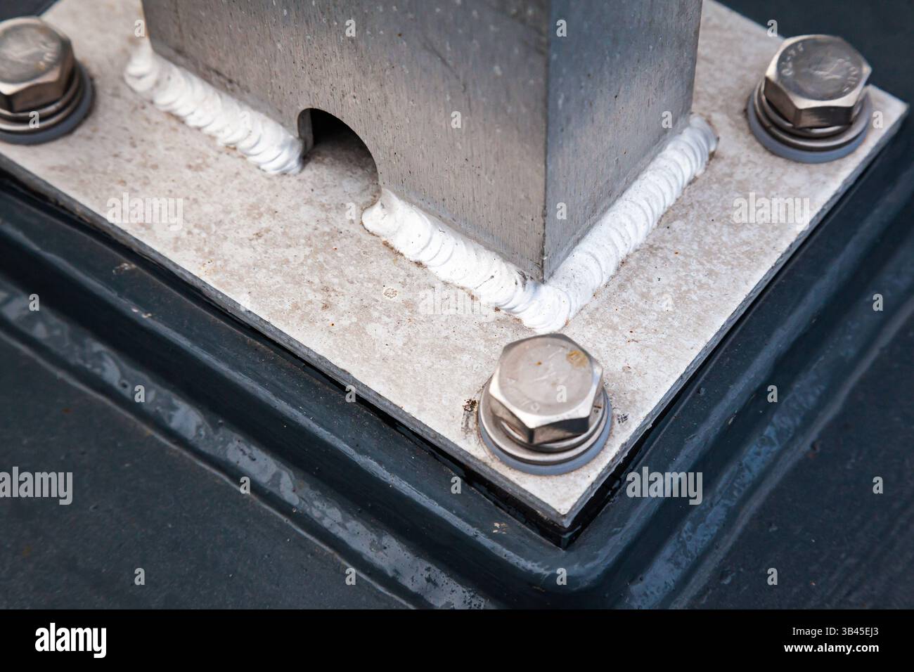 A welded aluminum post welded to the plate and bolted to the deck ...