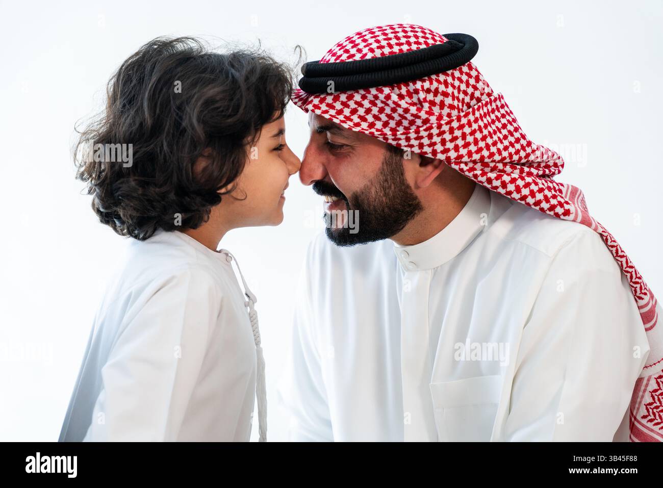 Happy arab family wearing saudi arabia clothing spending time together ...