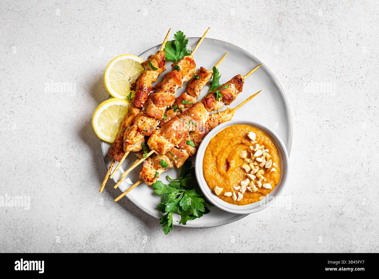 Grilled chicken satay with spicy peanut sauce on white background, top ...