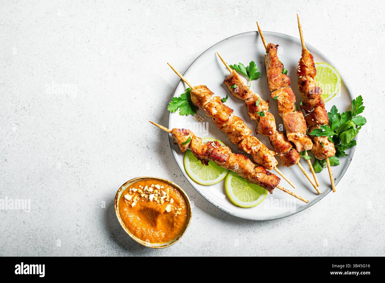 Malaysian chicken satay skewers with peanut sauce on white background ...