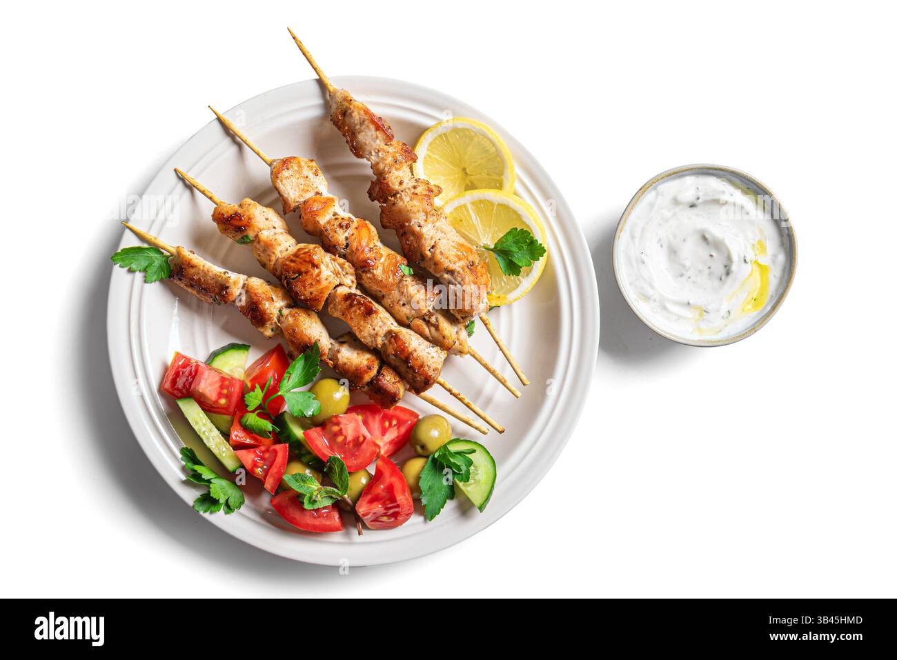 Grilled chicken kebab with fresh vegetable salad isolated on white ...
