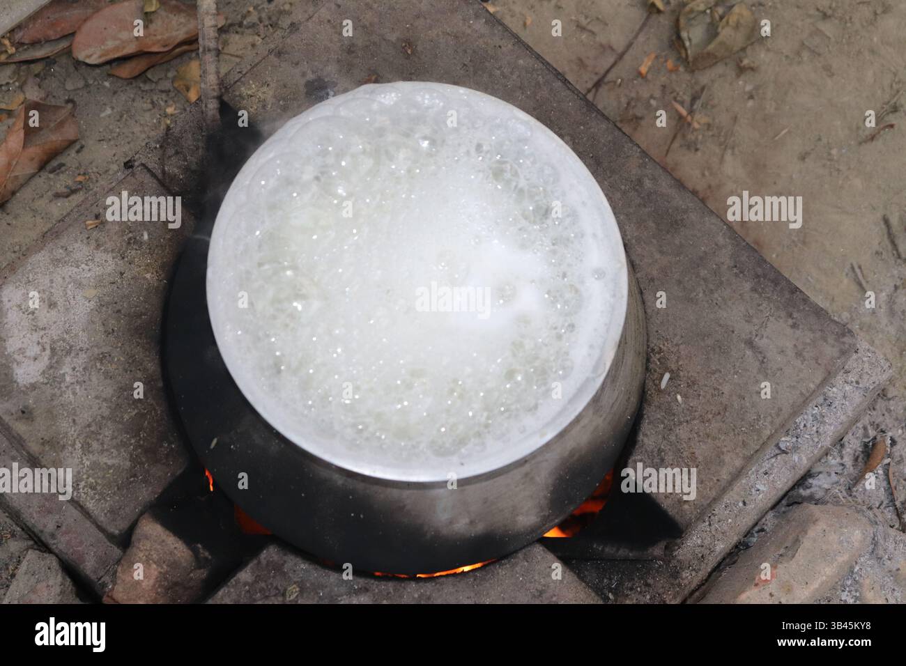 Top-down view capturing a black cooking pot with bubbling water, set ...