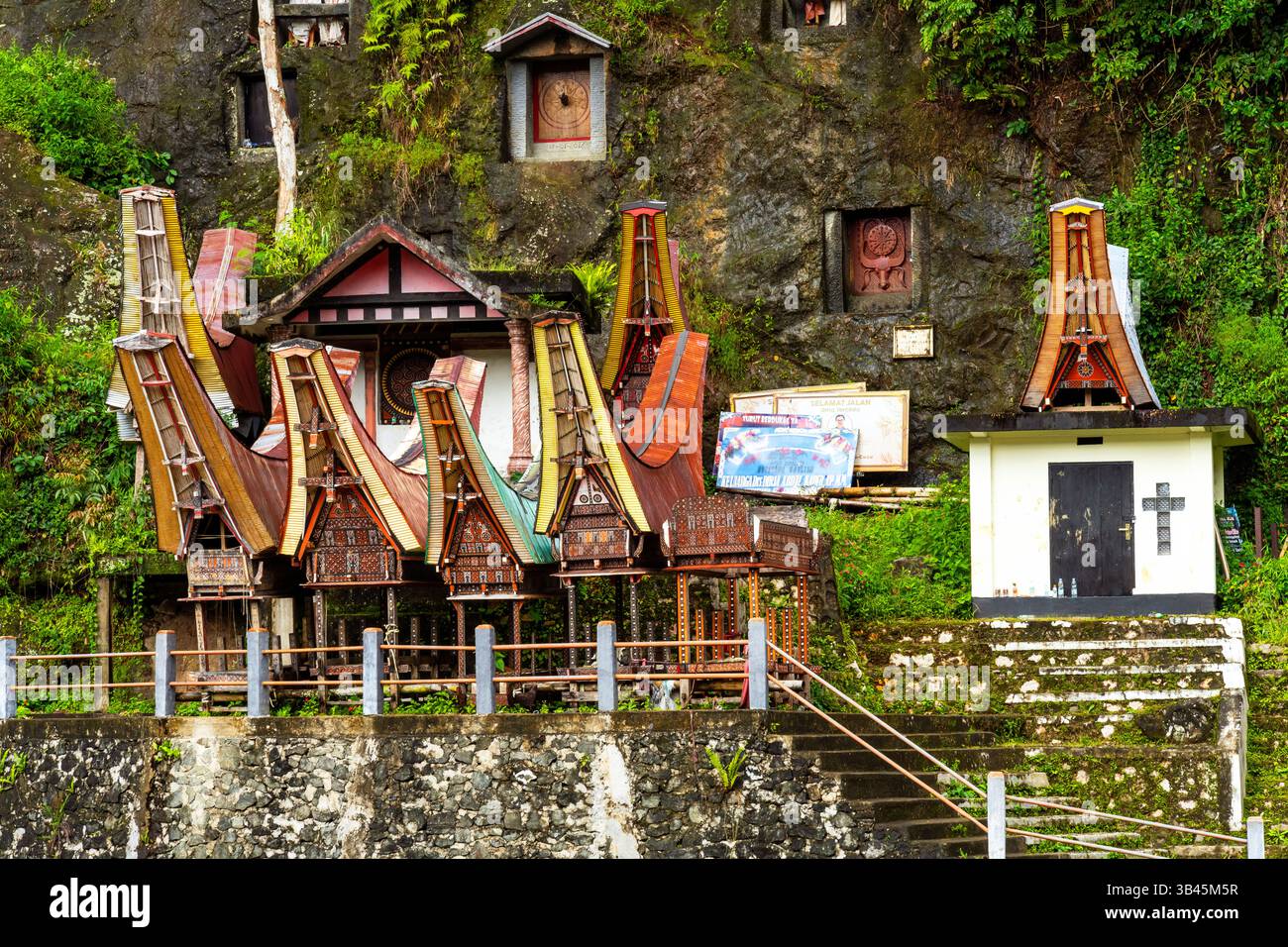 View boat-shaped house platforms by burial cliffs in Lemo village. One ...