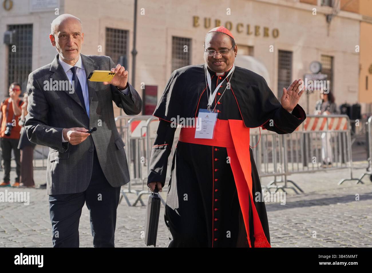 Indian Cardinal Antony Poola, right, is approached by a reporter as he ...