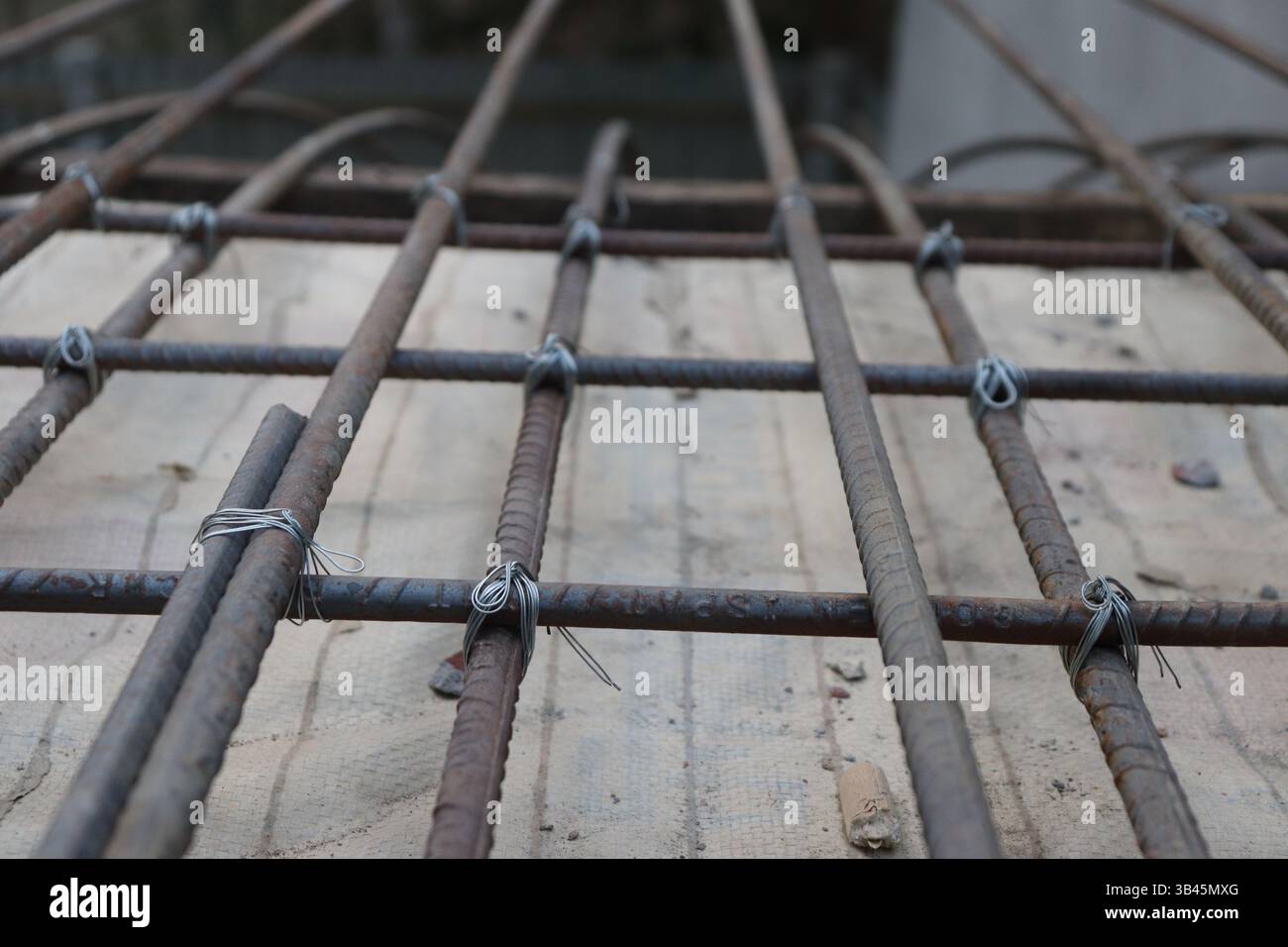 Grid of rusty rebar arranged and tied together using metal wire. Steel ...