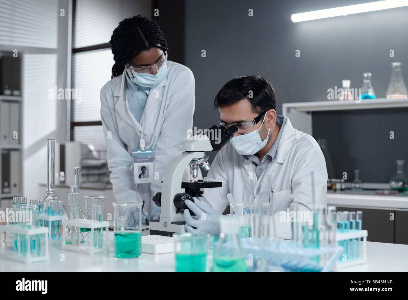 Scientists working diligently microscope hi-res stock photography and images - Alamy