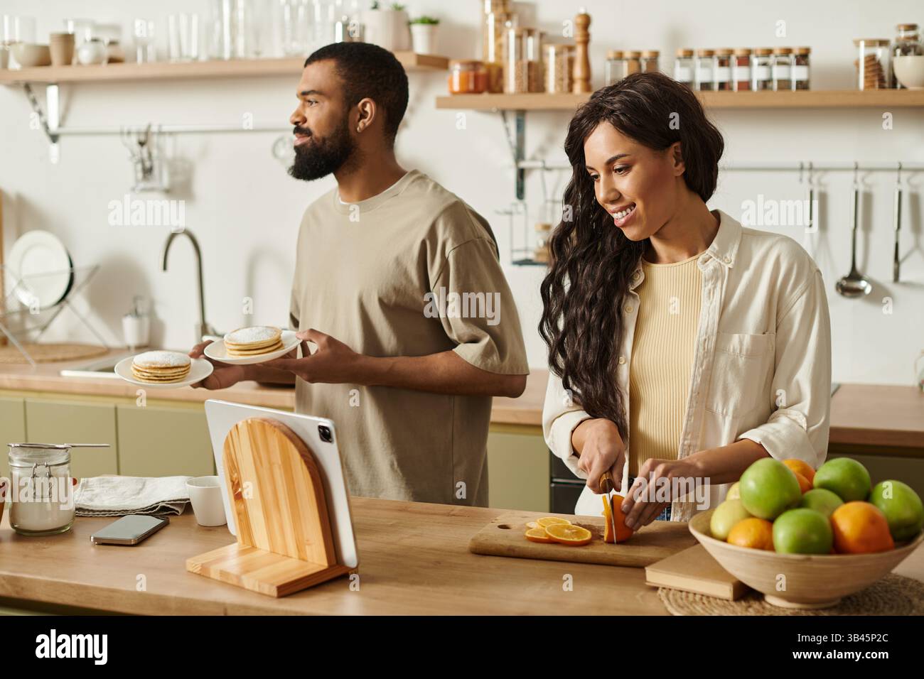 A loving couple shares joyful moments cooking together in their cozy ...