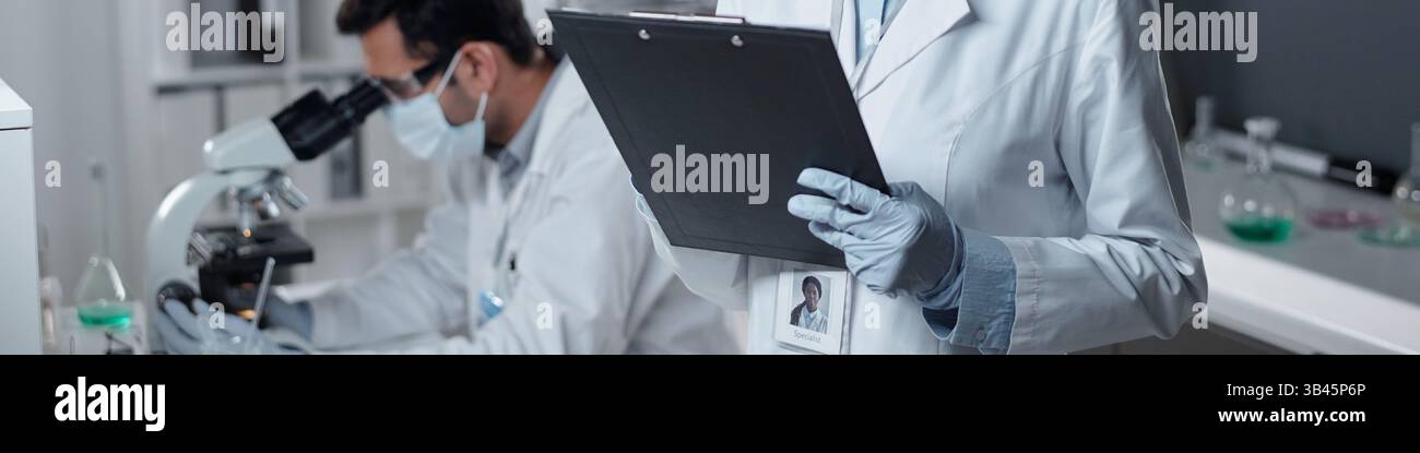Two scientists working diligently in a modern laboratory, using ...