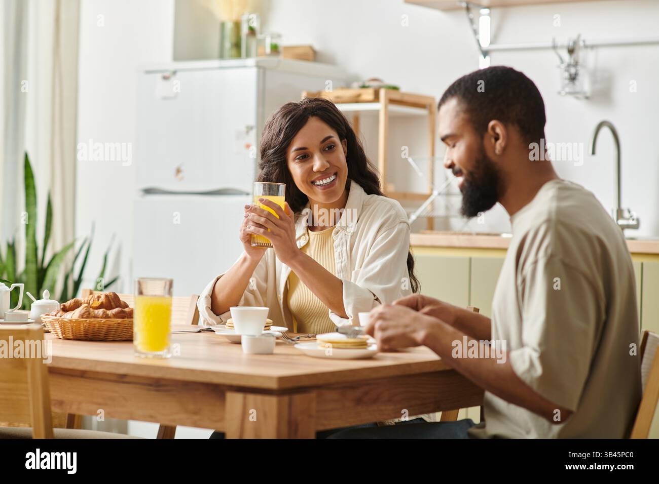 A loving couple enjoys a delightful breakfast together, sharing smiles ...