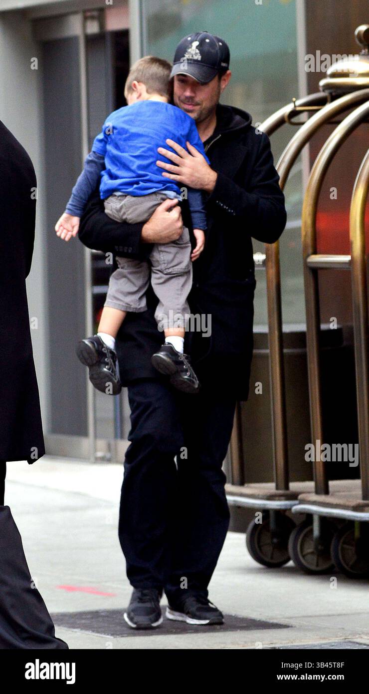 Carson Daly carries his son Jackson into a downtown hotel in New York ...