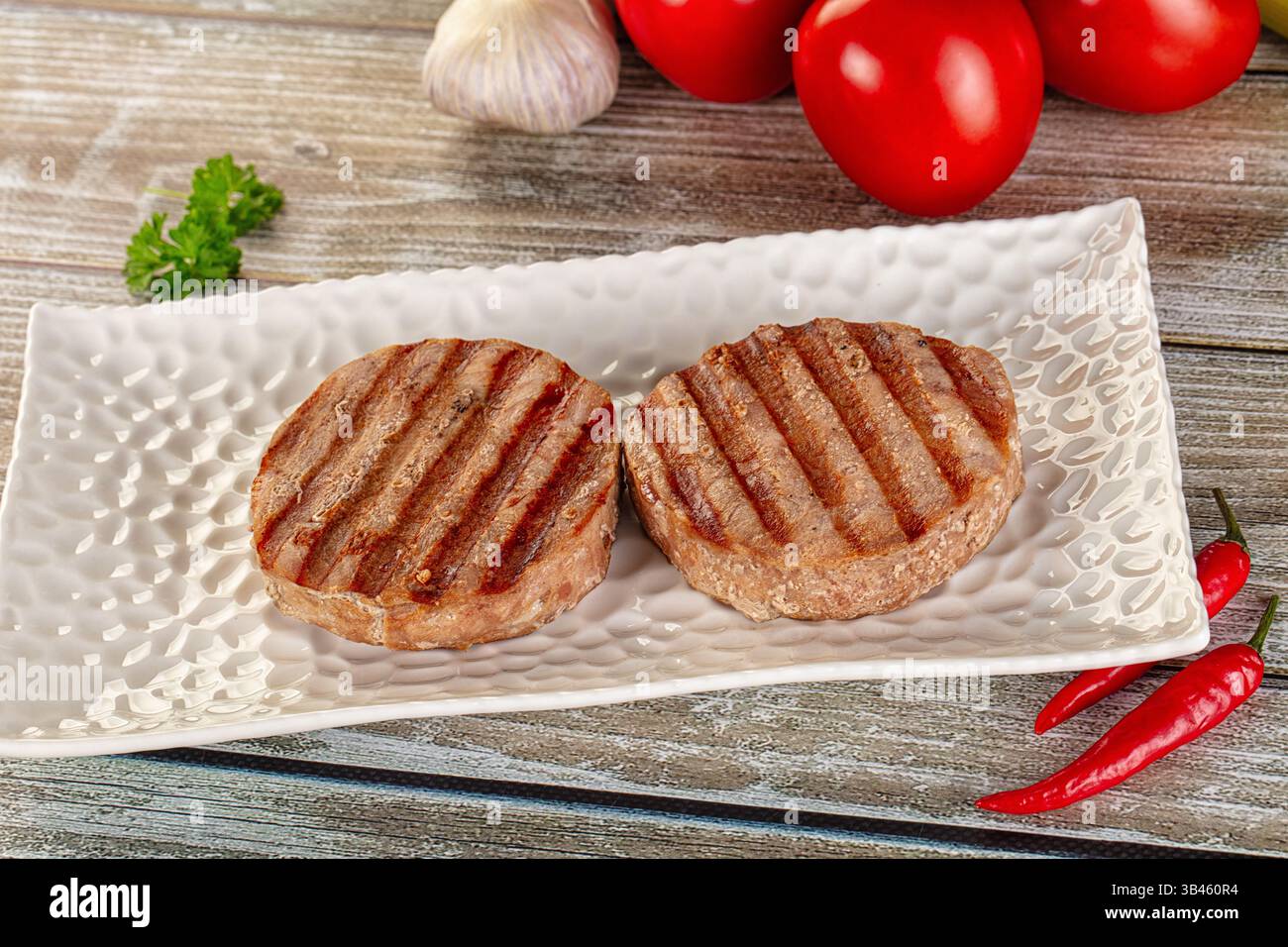Grilled tuna steak fillet round medallion Stock Photo - Alamy
