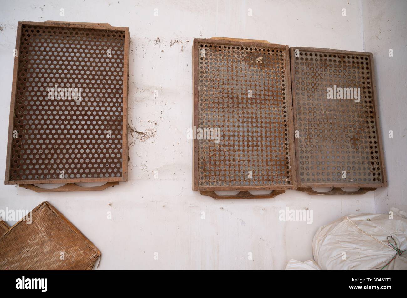 Work equipment in ginger spice factory in India, sieve on the wall ...