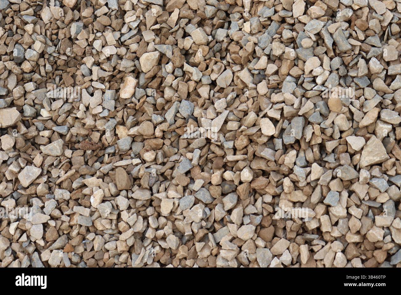 Shows a full frame view of a pile of aggregate rocks of various sizes ...