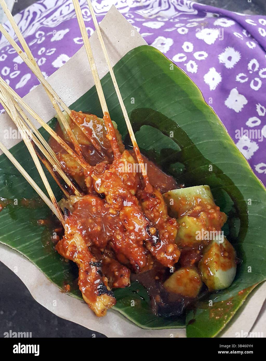Indonesian Sate or Ayam Chicken Satay with lontong rice cake and peanut ...
