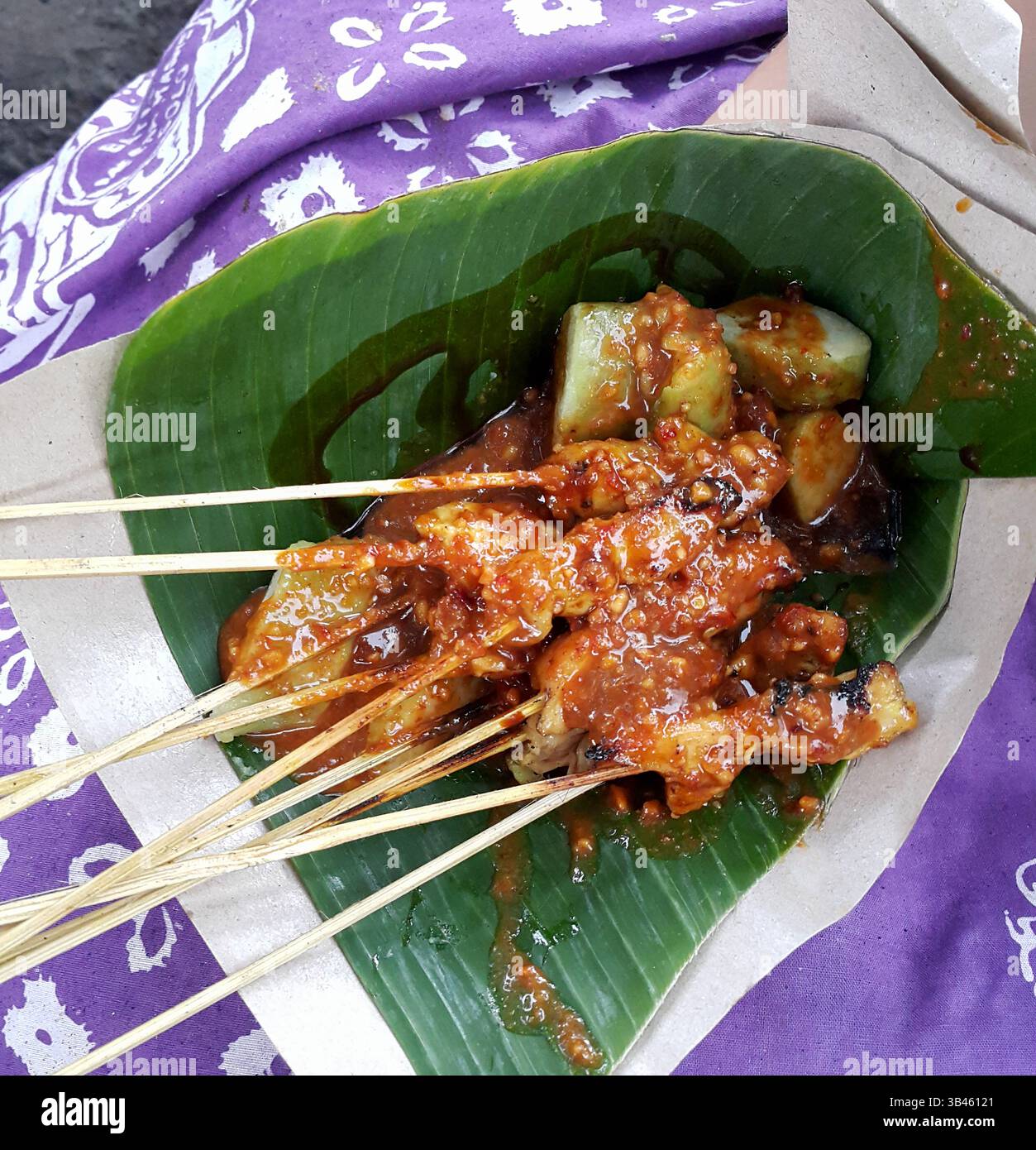 Indonesian Sate or Ayam Chicken Satay with lontong rice cake and peanut ...