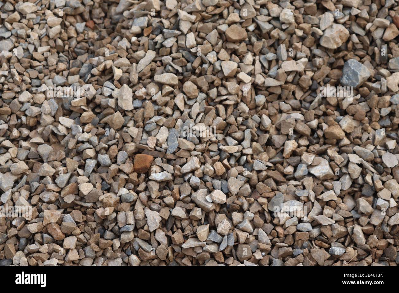 A top-down, full-frame view displays a collection of crushed stones ...