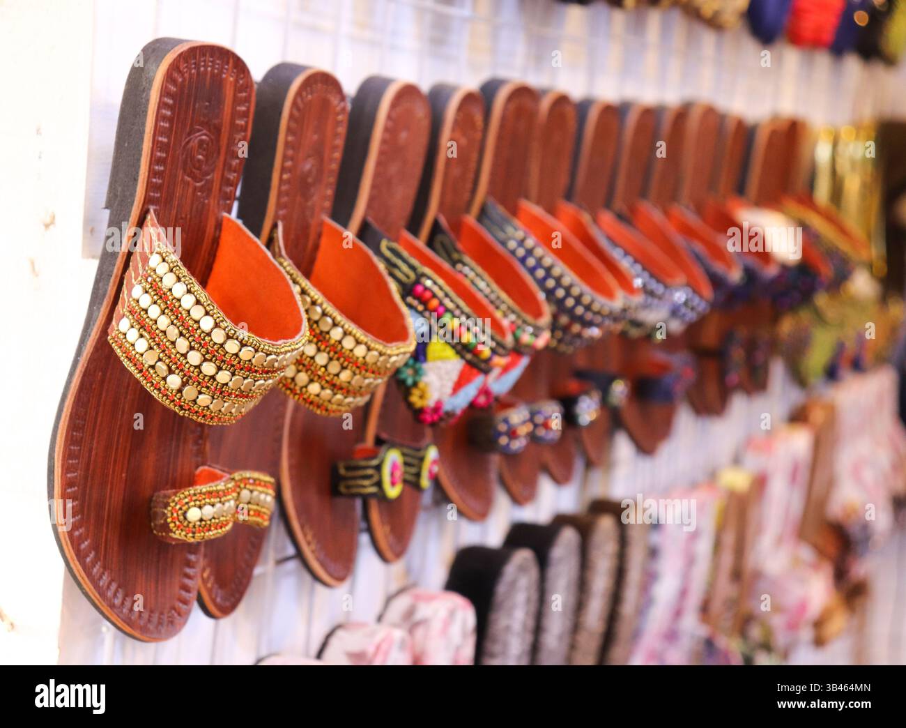 Rows of handcrafted ethnic Kolhapuri chappals. Leather sandals feature ...