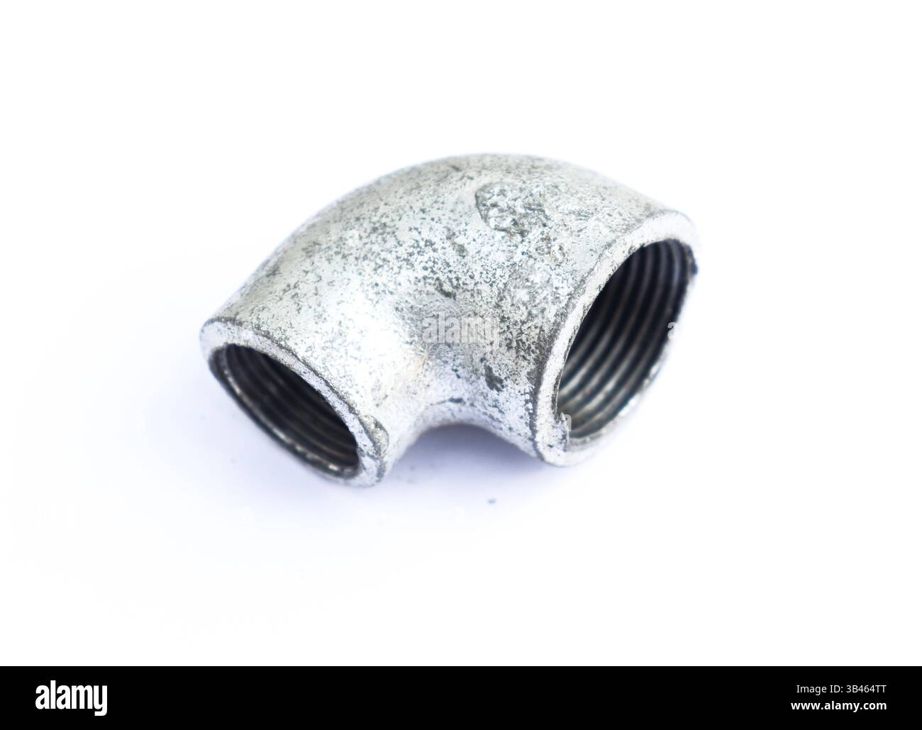 Close-up captures a galvanized metallic 90-degree elbow pipe fitting ...
