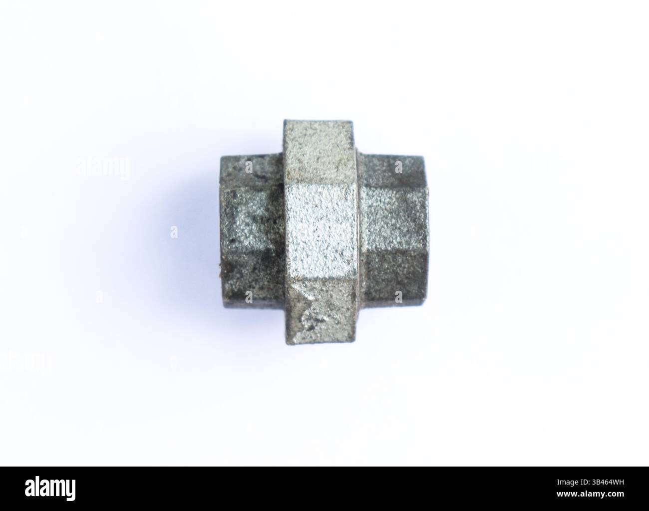 Close up of galvanized metal pipe fitting union, with a rough surface ...