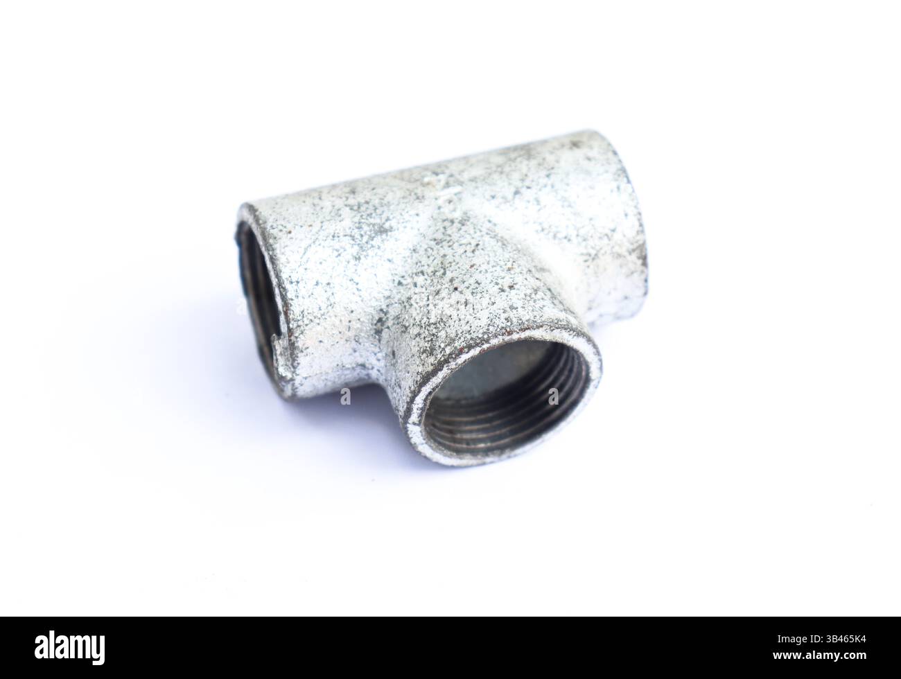 Close-up captures a plumbing T joint, showcasing threaded connections ...