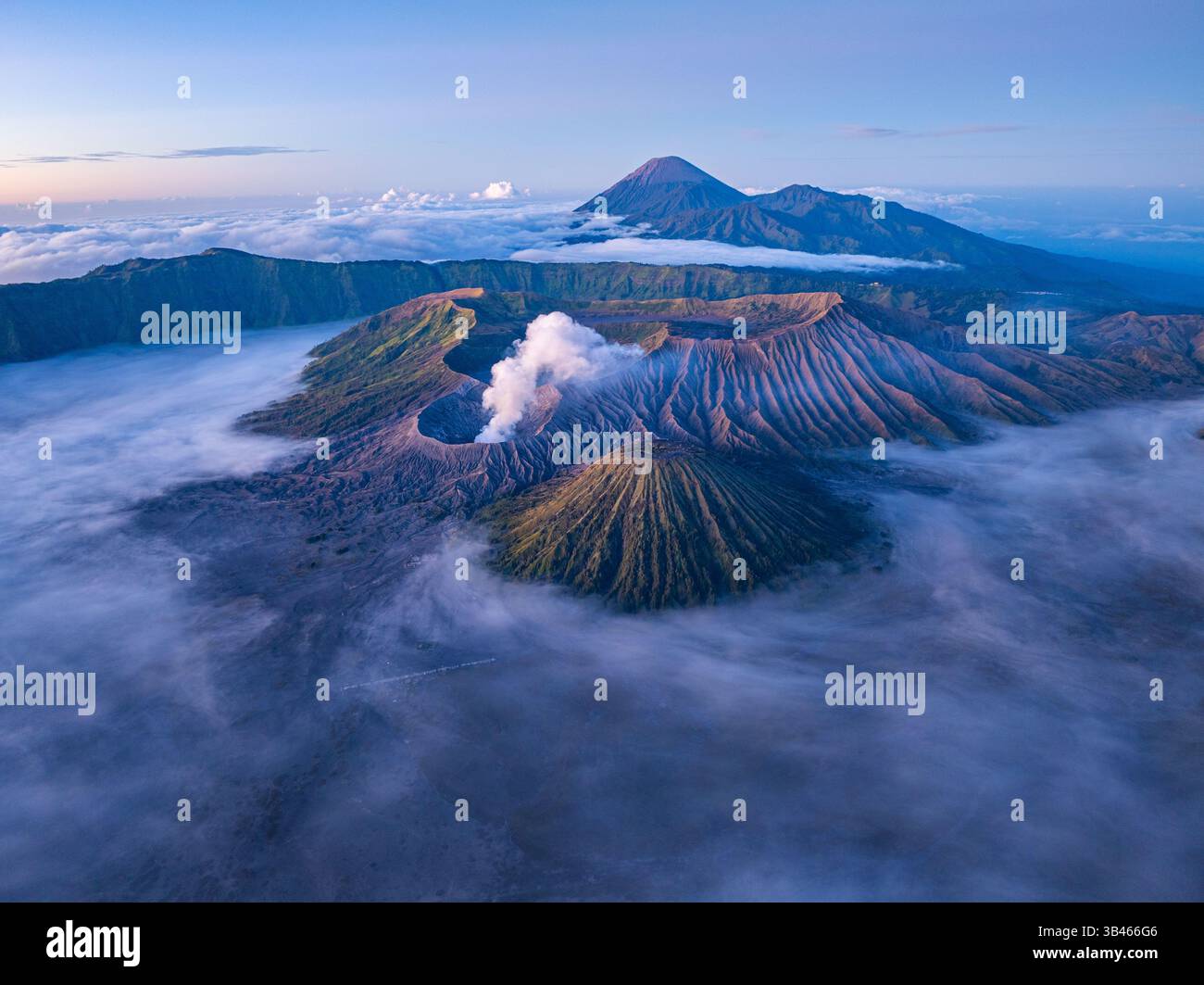 aerial view of breathtaking Mount Bromo surrounded by mist and dramatic ...