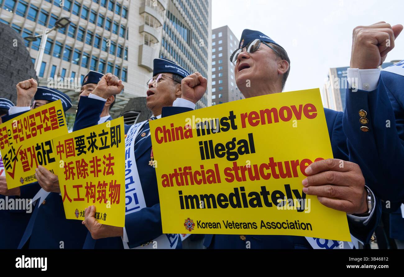 Members of the Korean Veterans Association hold placard during a ...