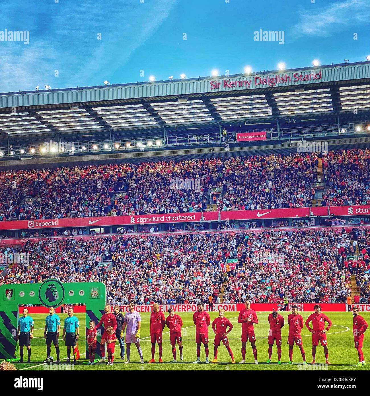 Liverpool players and referee and assistants line up before kick-off ...