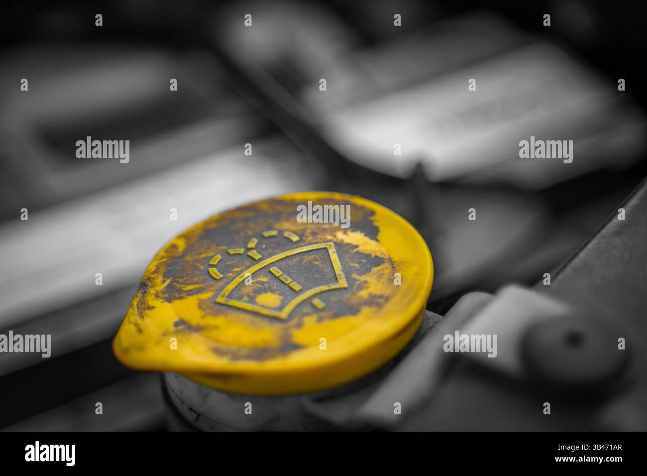 Car windshield washer filler cap, yellow Stock Photo - Alamy