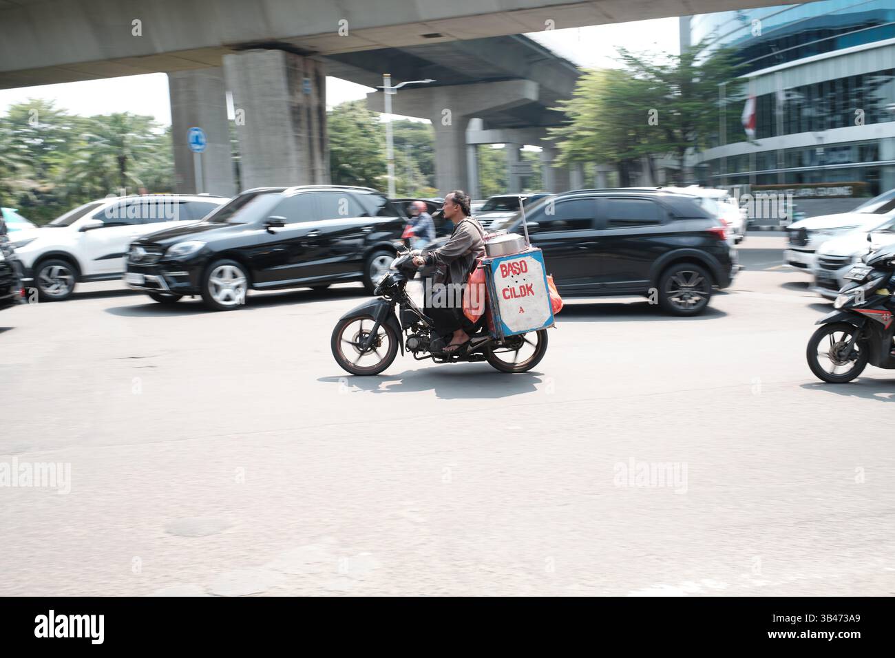 Fast moving Motorcycles or Bikers while background is in motion blur on the streets in Asia ...