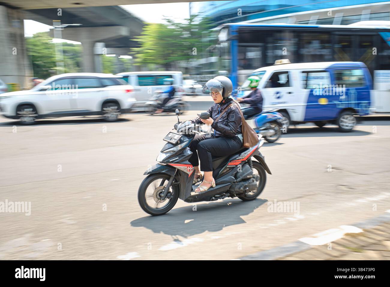 Fast moving Motorcycles or Bikers while background is in motion blur on the streets in Asia ...