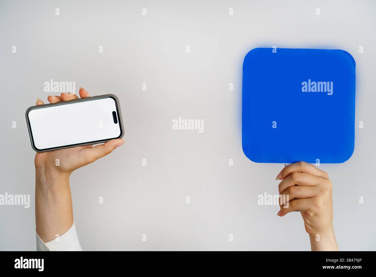 cell phone blank white screen mockup and blue round sign. hands of ...