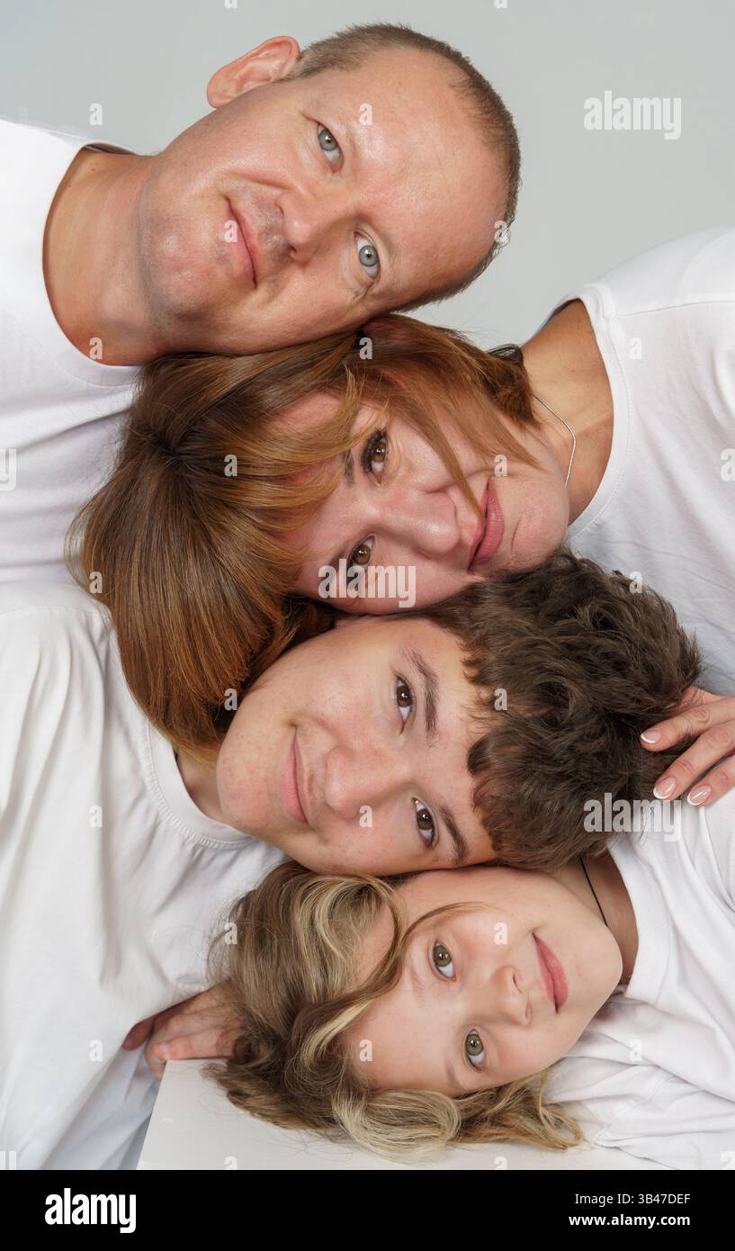 vertical portrait of family, parents and teenage boy and girl. Pyramid ...