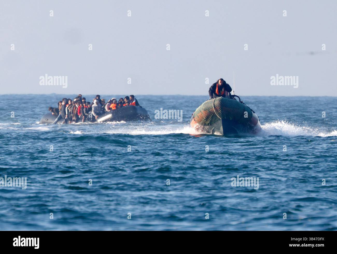 A packed migrant dinghy is seen in French territorial waters of The ...