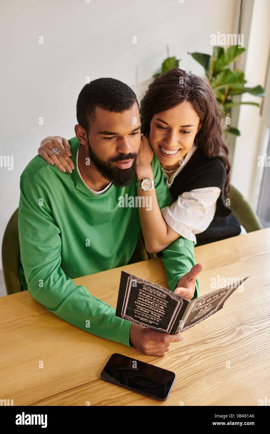 Loving couple shares a warm moment in a cafe, exploring menu options ...