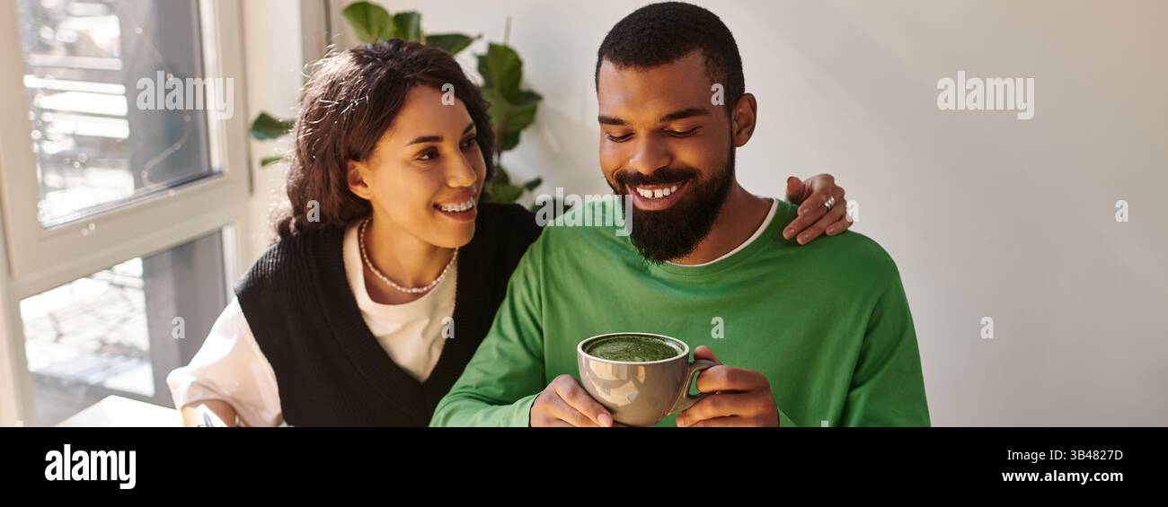 A joyful couple shares laughter and warmth over matcha latte in a ...