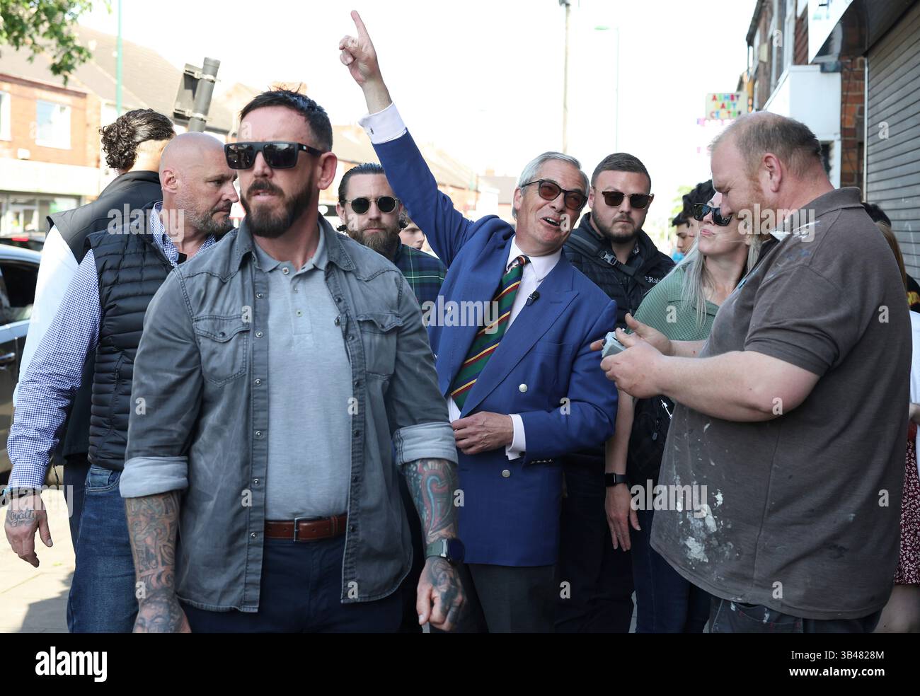Reform UK leader Nigel Farage gestures as he campaigns with Reform UK ...