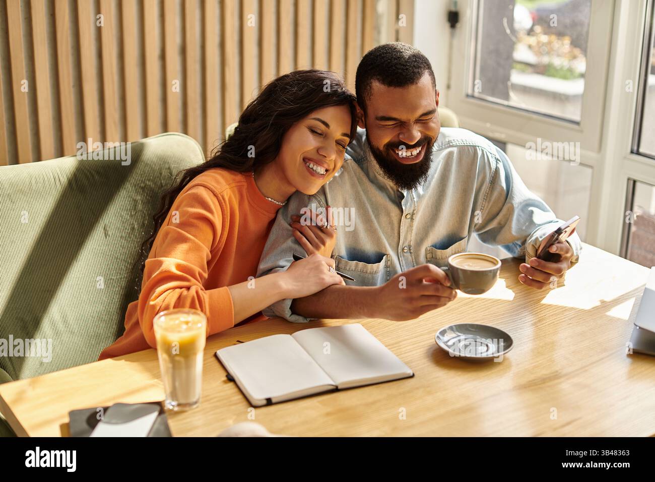 An african american couple shares joyful moments over coffee at a cafe ...