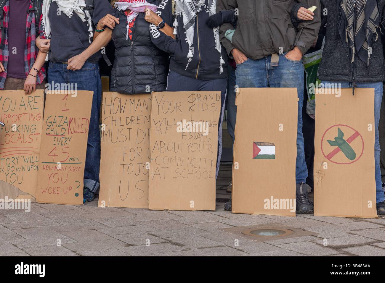 Samlesbury, UK. 30 APR, 2025. Activists hold various signs outside the ...